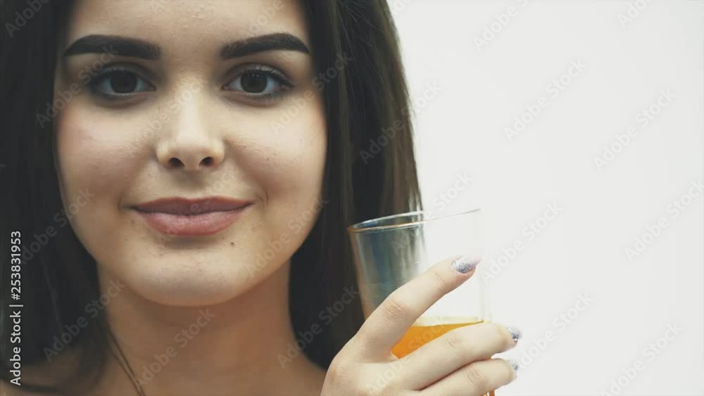 Close up picture of glad gorgeous woman drinking sweet orange juice ...