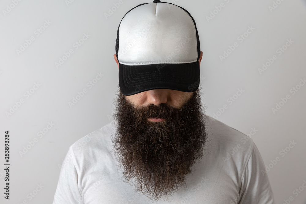 Hipster handsome male model with beard. Baseball cap with space for ...