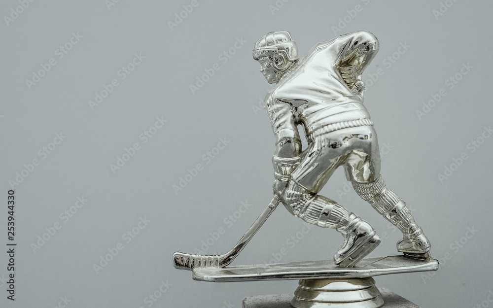 Poster Shining silver metal statue of ice hockey in front gates with ...