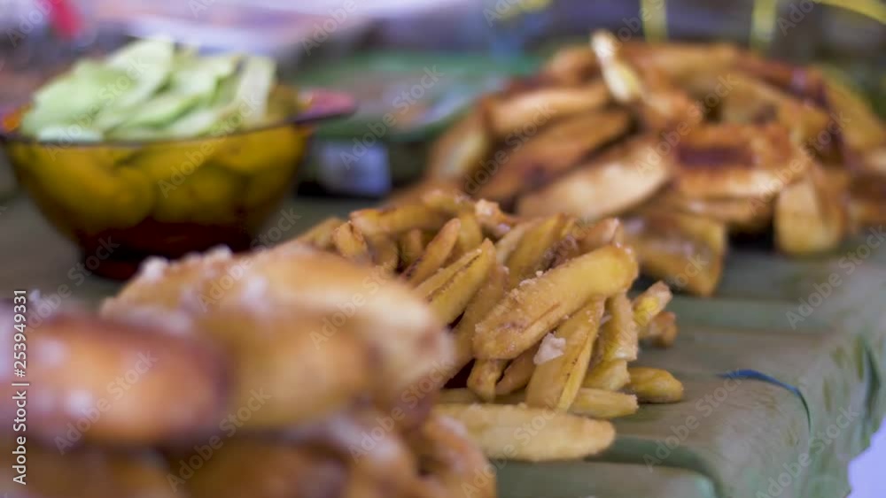 Plantains, bananas, sea urchin and other fresh food dishes placed on a ...