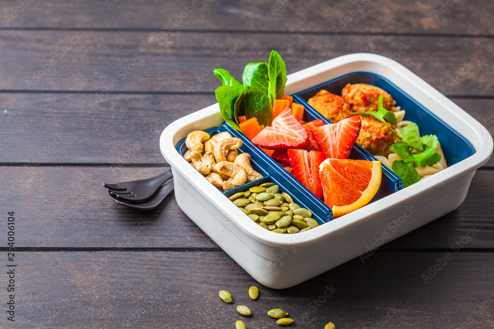 Healthy food lunch box. Vegan food: beans meatballs, pasta, vegetables ...