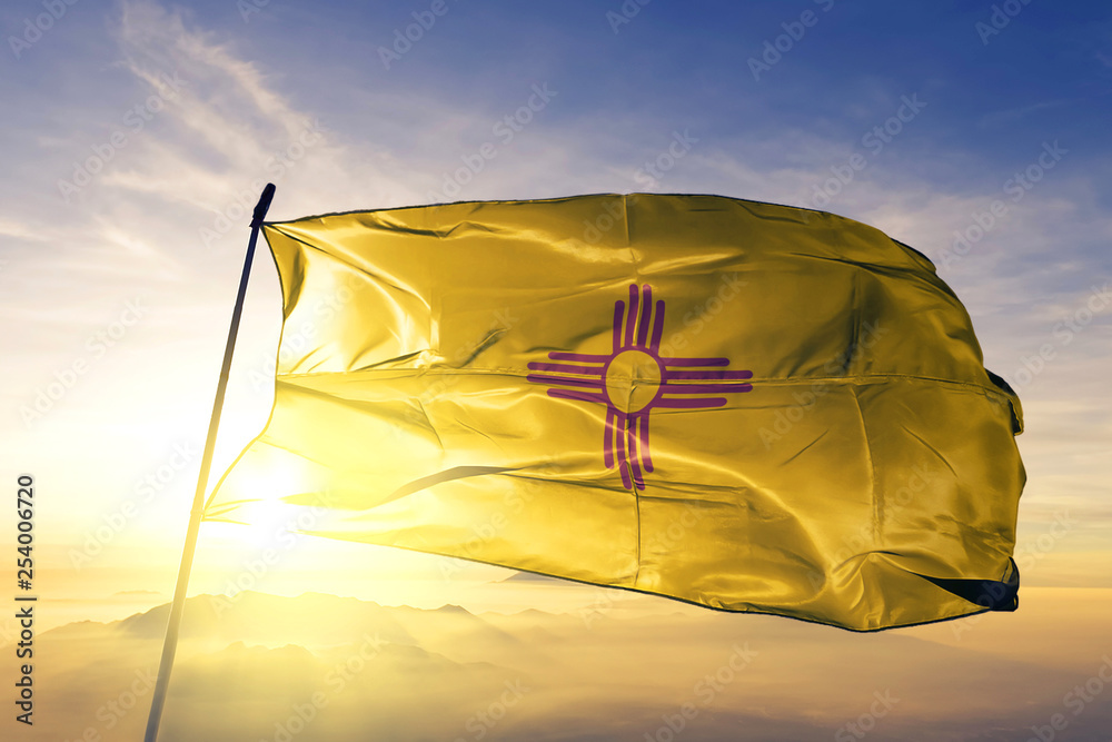 New Mexico state of United States flag waving on the top sunrise mist ...