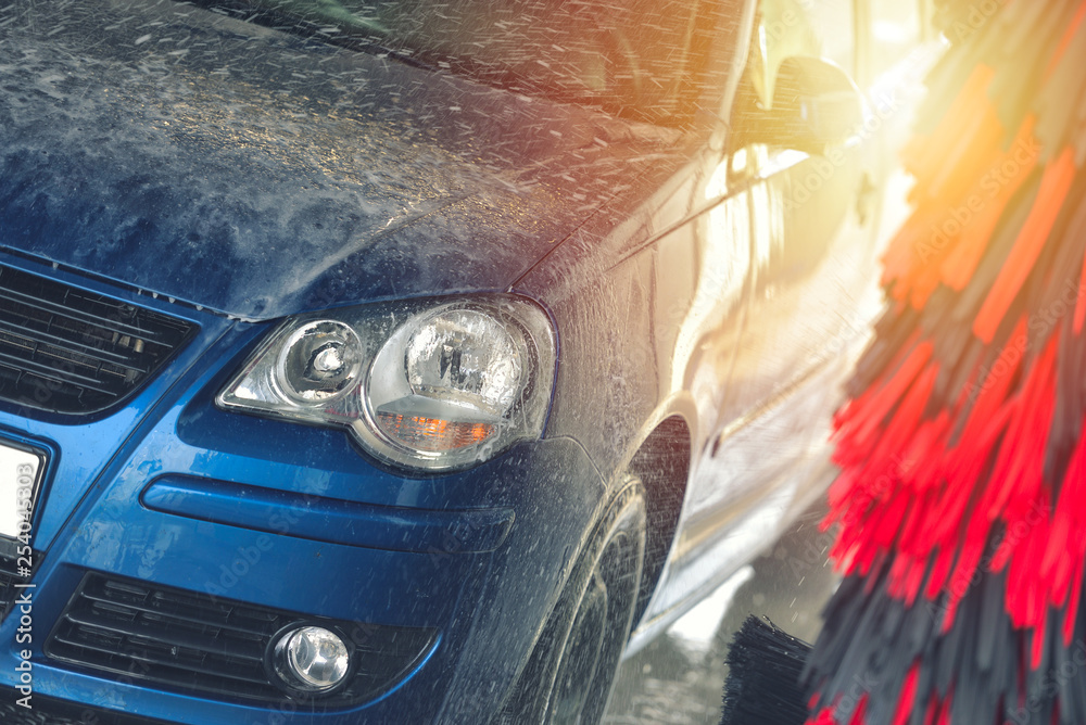 Automatic car wash in action. Car wash concept. Automated technology ...