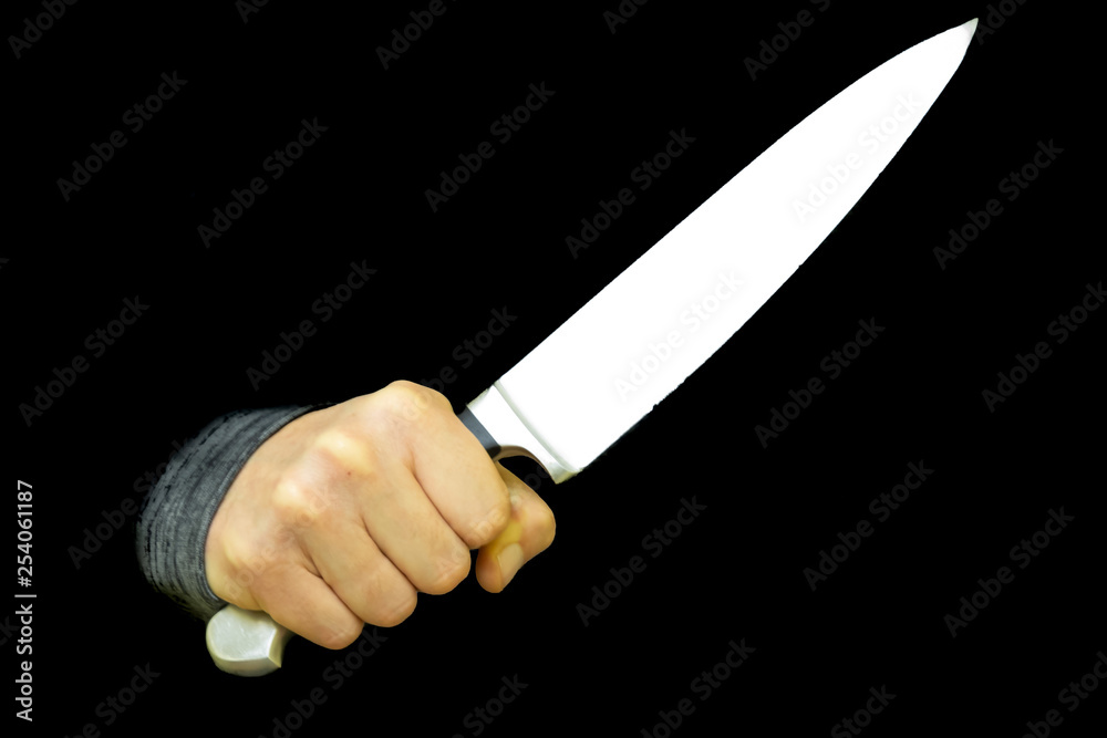 close up of a hands holding a knife of dangerous hooded man standing in ...