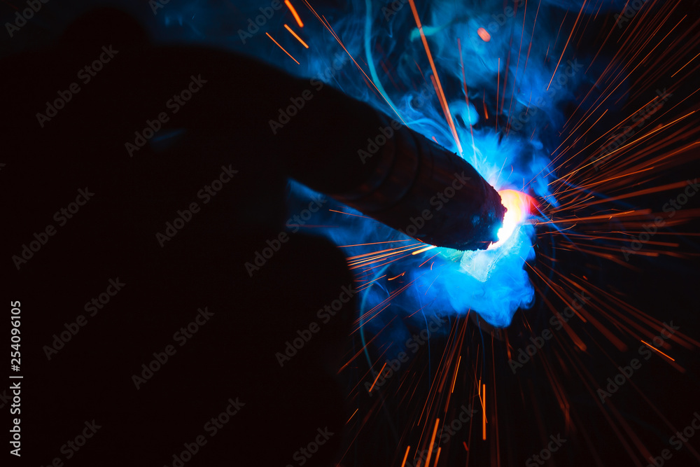 Arc welding. Welding of two metal plates in inert gases. MIG / MAG. A ...
