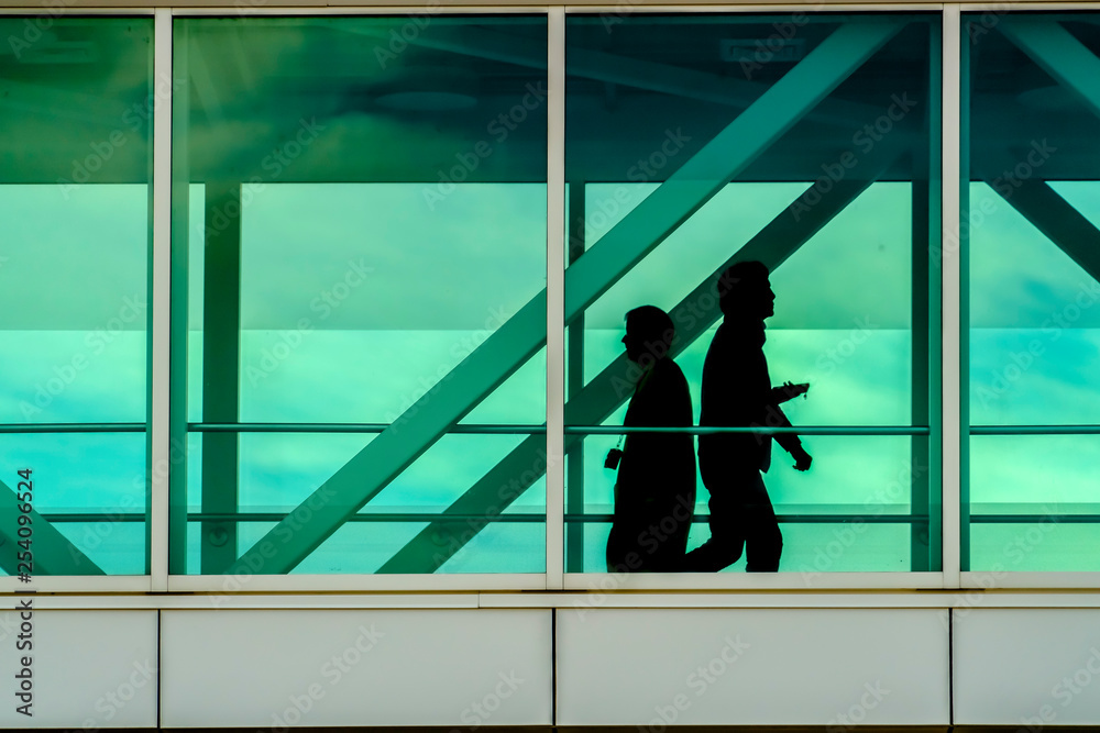 Silhouette of people seen through glass windows Stock Photo | Adobe Stock