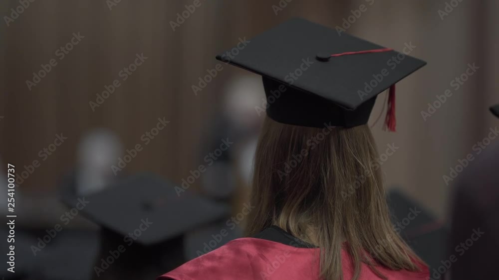 Video from a backside of a young girl who is graduated from the uni ...