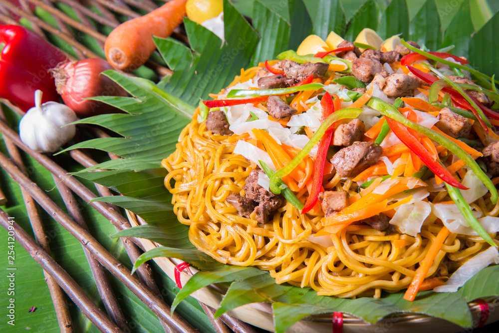 Pancit Guisado Bilao - Filipino noodles Bilao Photos | Adobe Stock
