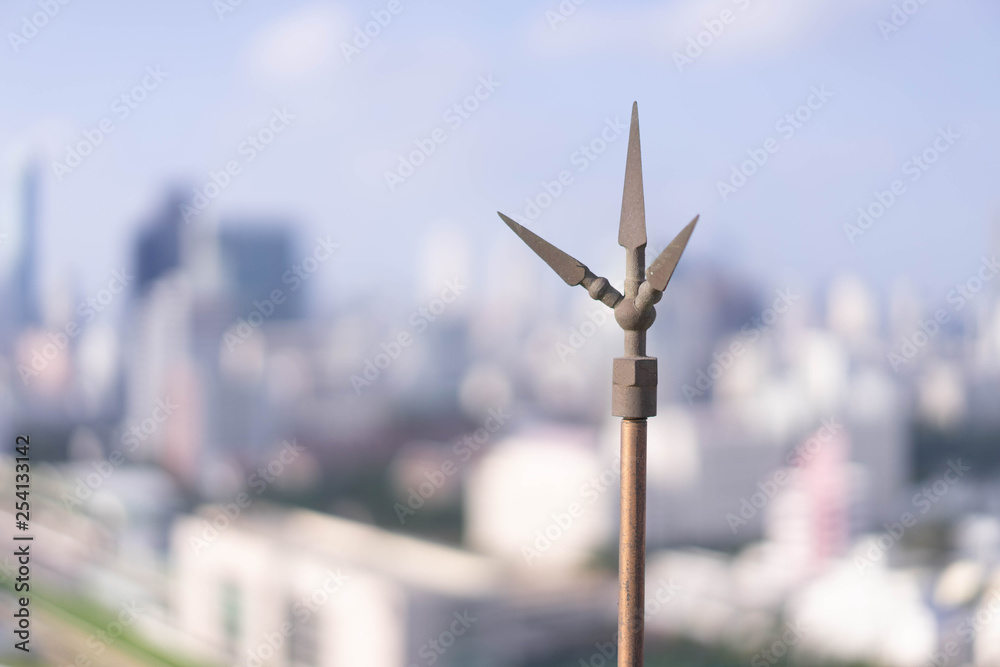 Lightning rod on the top of a tall building in a large city for safety ...