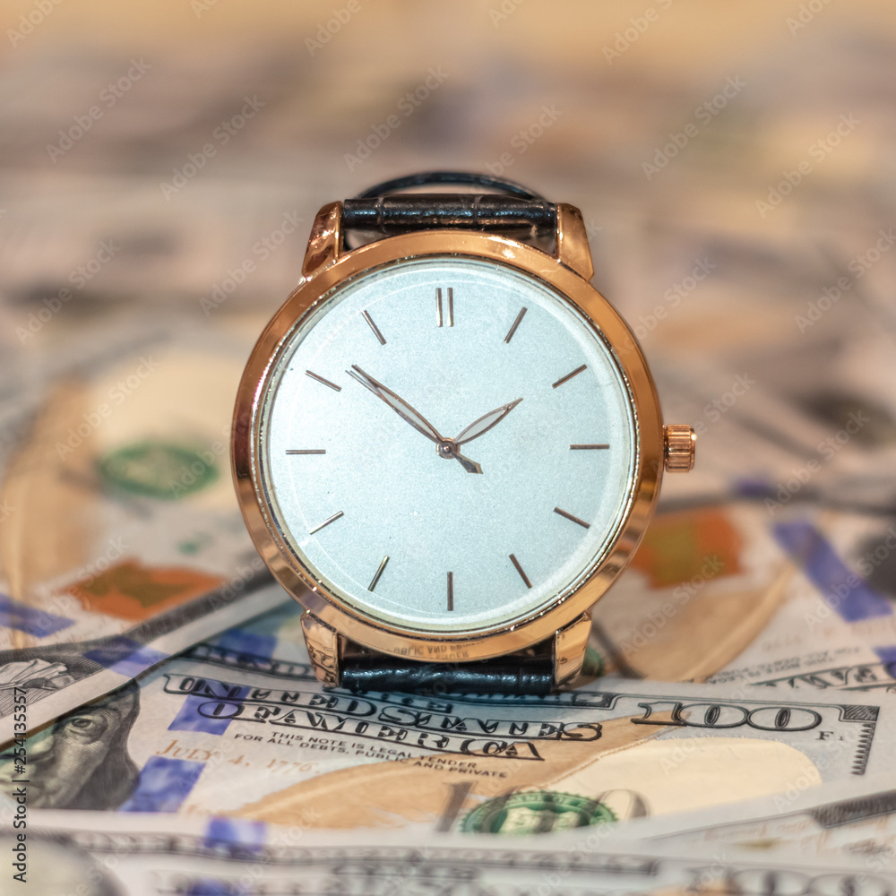 Management efficiency concept of time and money, wrist gold watch and ...