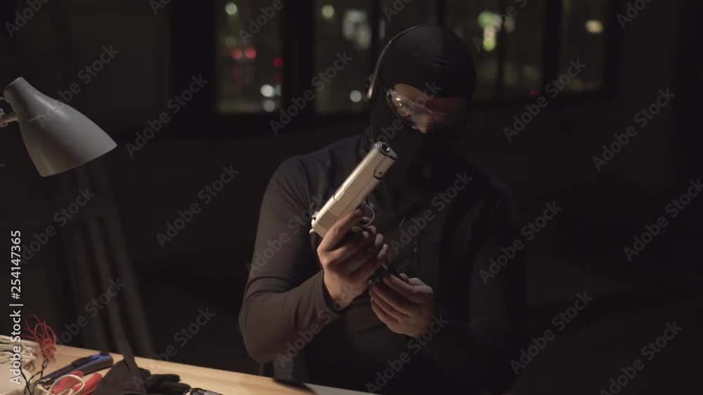 terrorist with a weapon on the background of the night city, charges ...