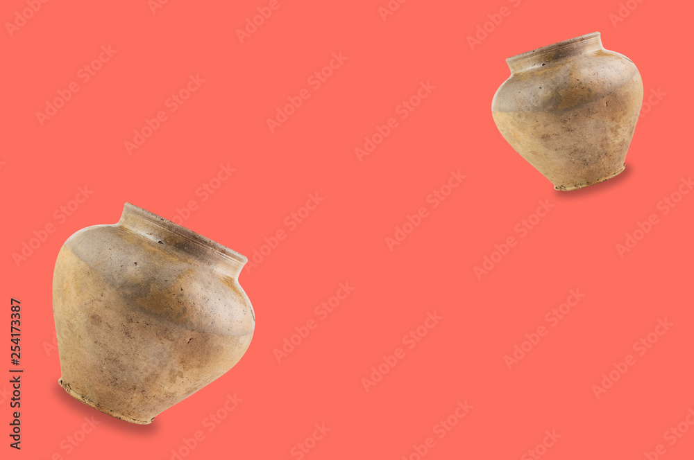 Fotka „Pair of old antique worn and dirty vases on coral color table ...