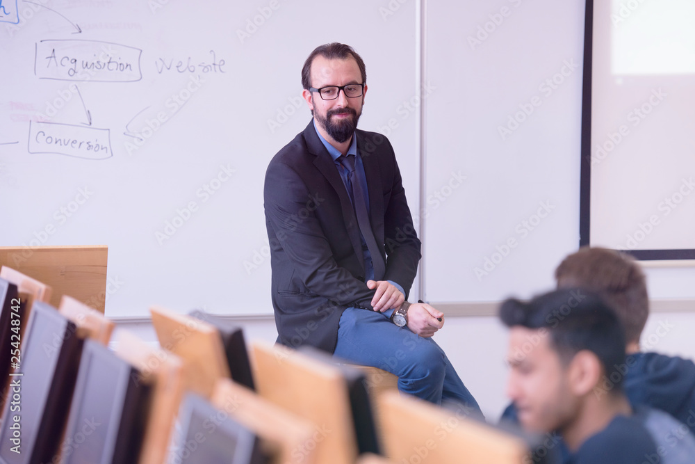 Group of students study with professor in modern school classroom. Male ...
