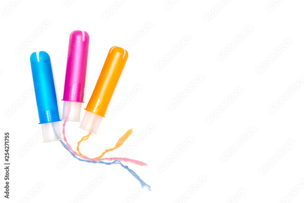 three cotton tampons with blue pink yellow applicartors isolated on ...
