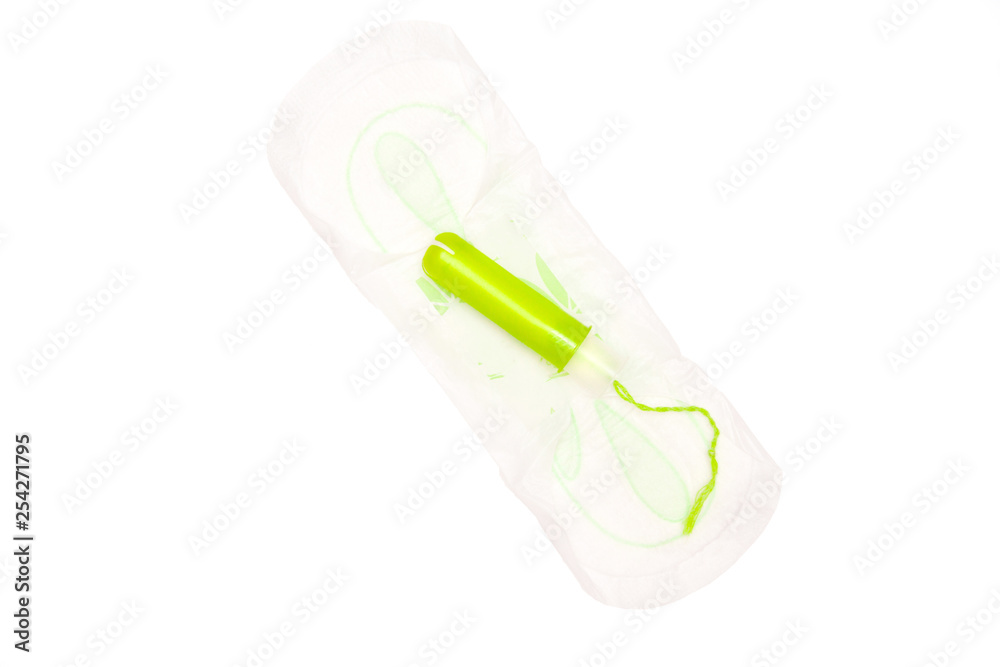 one cotton tampon with green applicartor on menstrual pad isolated on ...