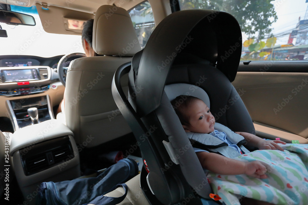 cute baby sitting in car seat safety drive with mother, happy family ...