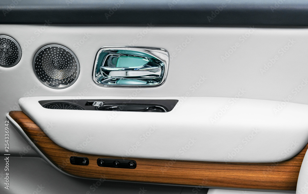 Door handle with power window control buttons of a luxury passenger car ...