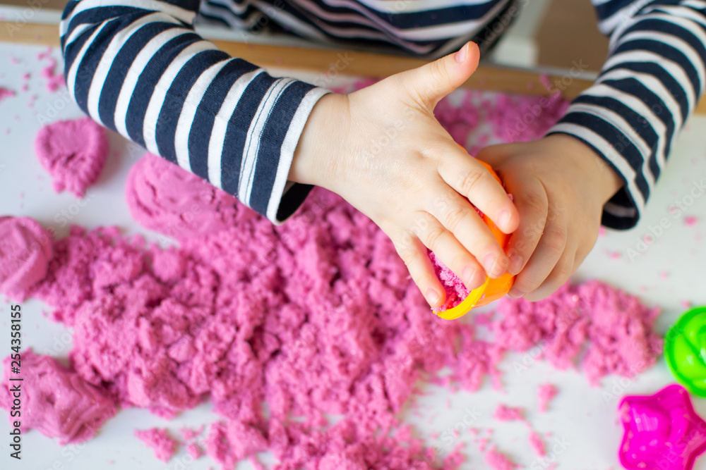 Little Happy Caucasian Girl Playing with Pink Kinetic Sand at Home ...
