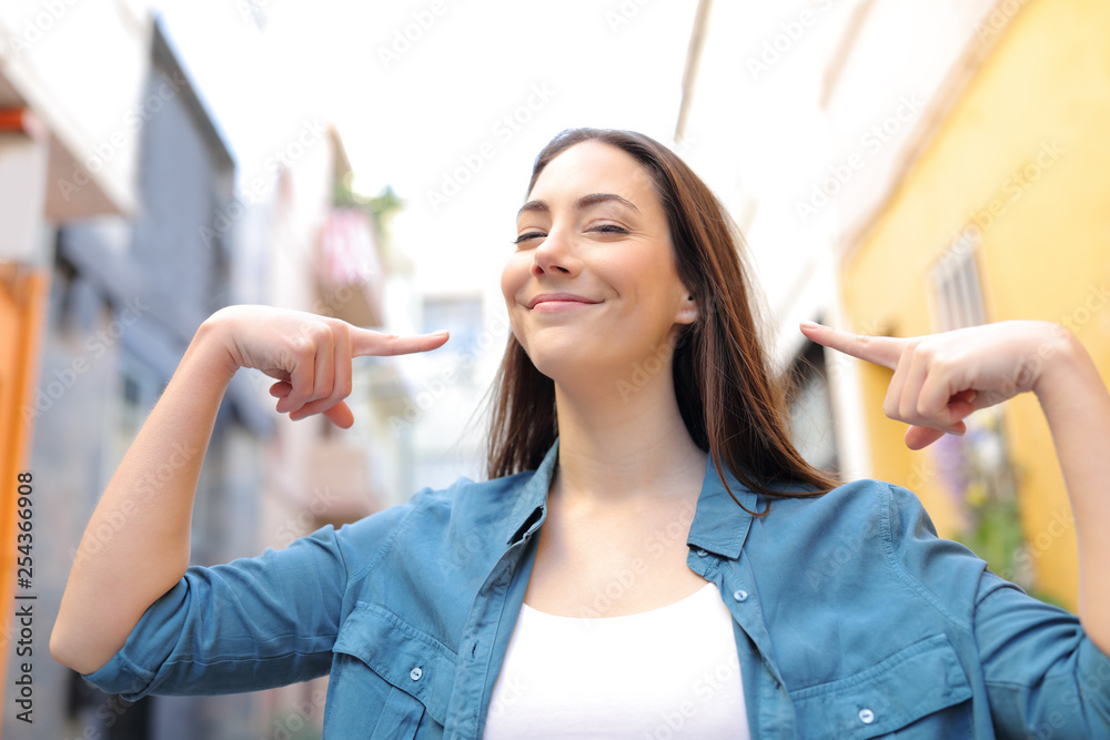 Proud woman pointing herself in the street Stock Photo | Adobe Stock