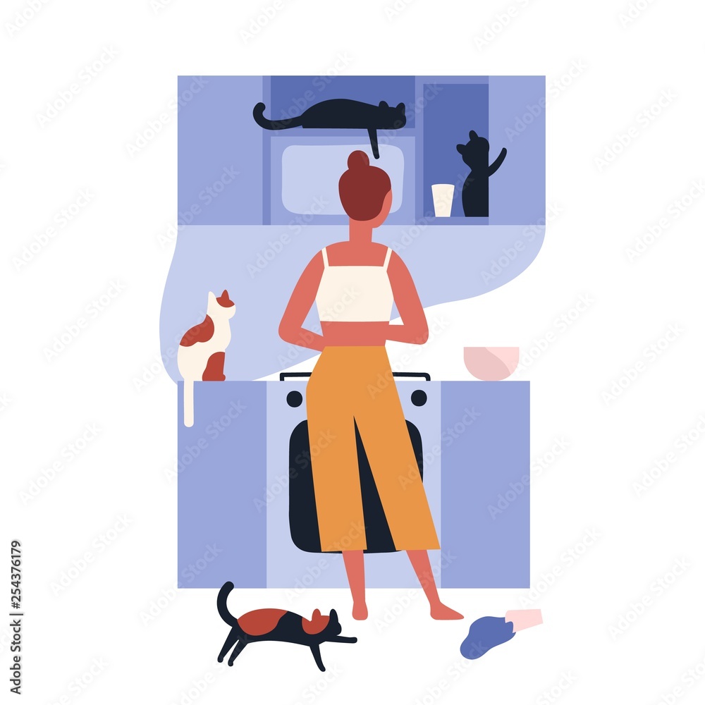 Crazy cat lady standing in kitchen full of her kitties and cooking ...