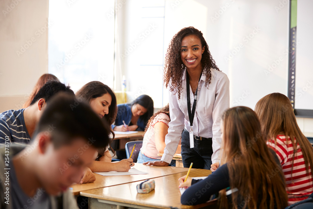 Portrait Of Smiling Female High School Teacher Standing By Student ...