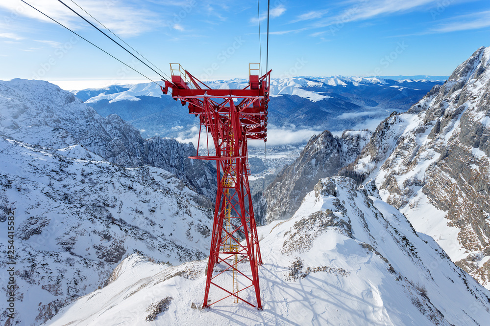 Red Cable Car Pylon and cables way at mountains landscape. Blue sky and ...
