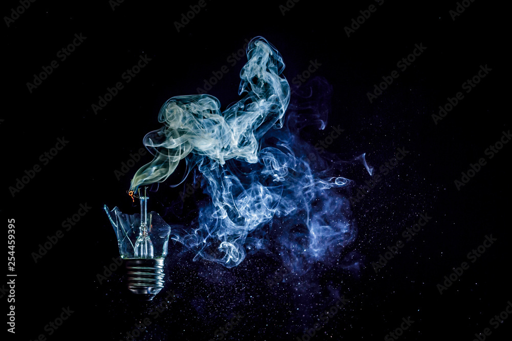 Сosmic explosion of burning light bulb with flying splinters of broken ...