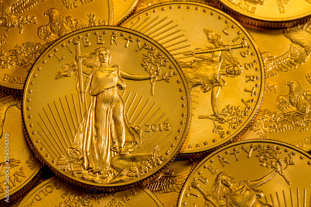 Pile of golden coins with Liberty on US Treasury issue Gold Eagle one ...