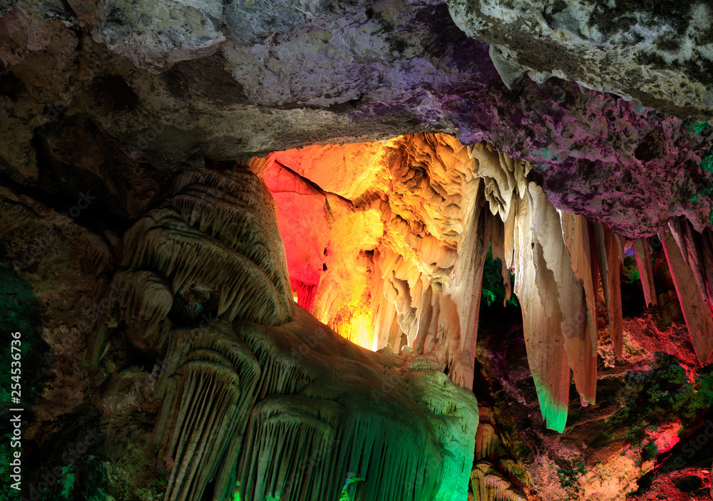Abstract cave interior chamber photograph - colored lights, bumpy rock ...