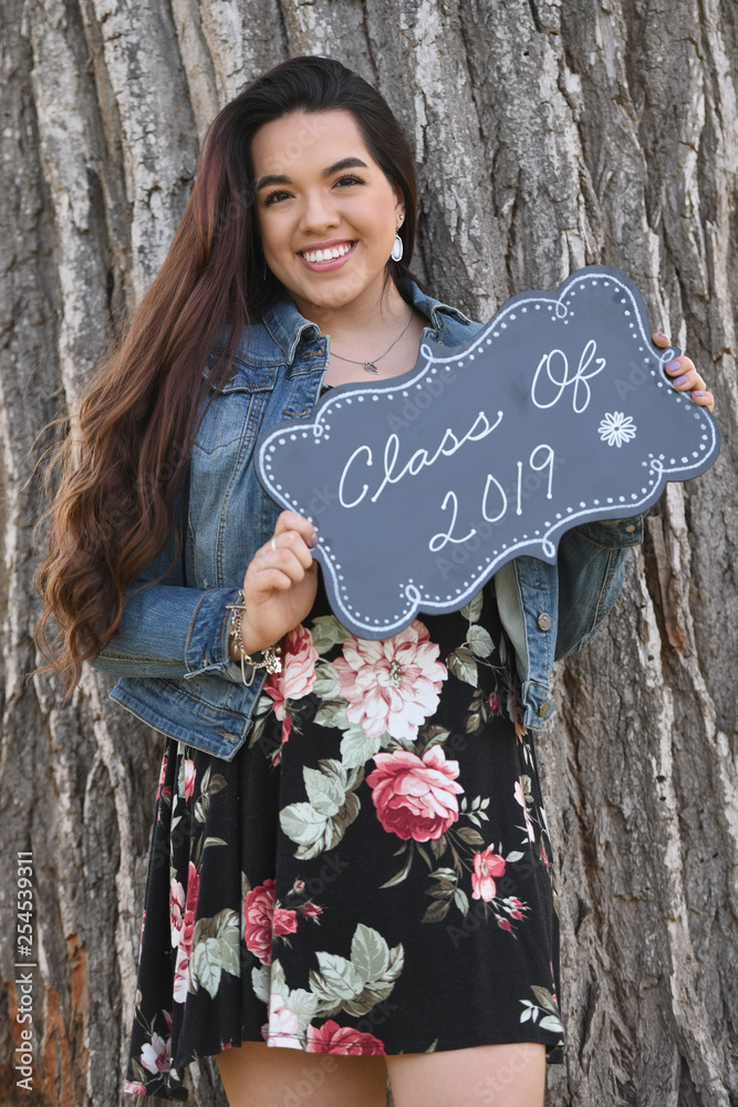 Beautiful high school senior at the park. Posing for graduation ...