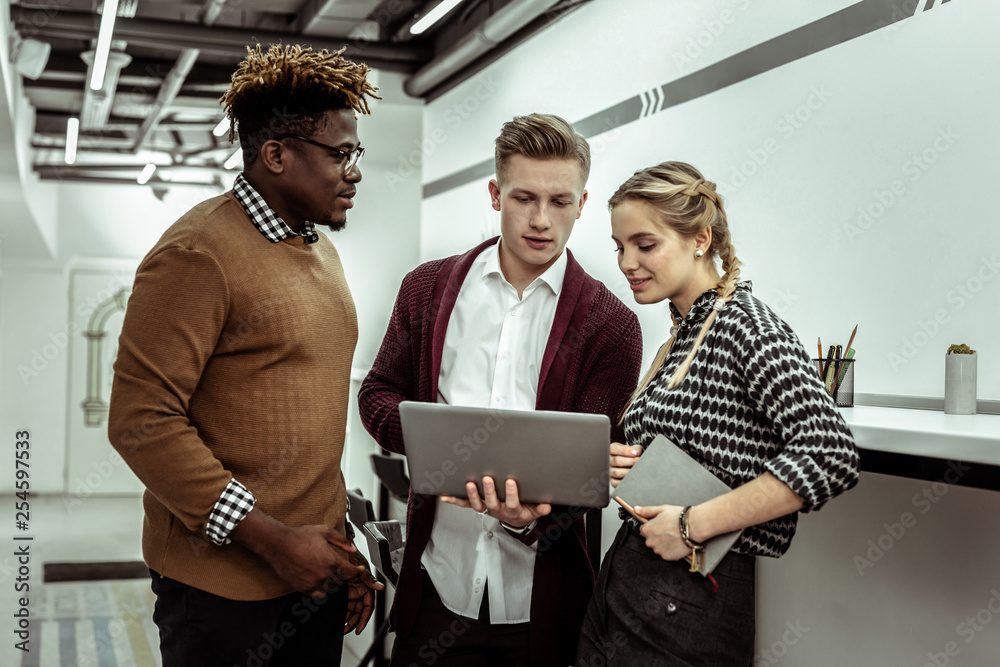 All workmates standing together in working area of their office Stock ...