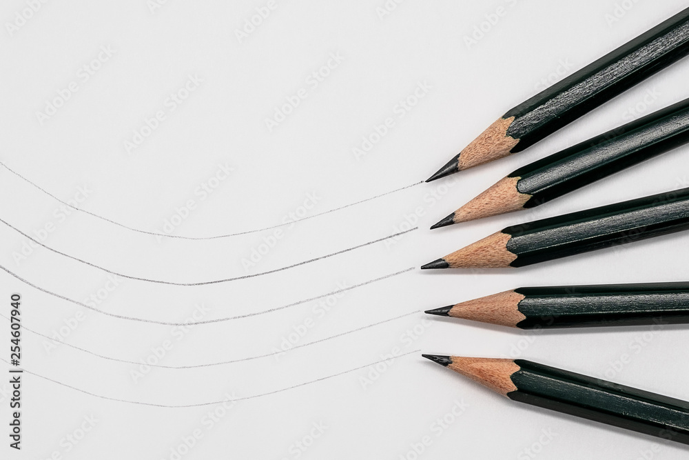 5 artist pencils lying on white paper, example line thickness Stock ...