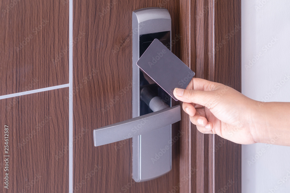 Hand using electronic smart contactless key card for unlock door in ...
