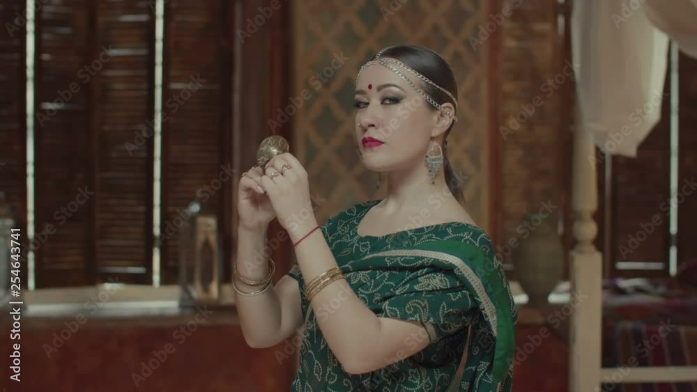 Stunning woman performing music on traditional indian musical ...