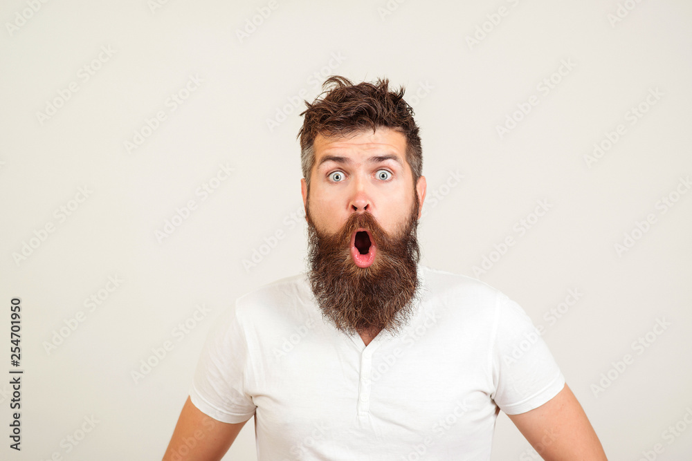 Shocked bearded man stares at camera. Bearded hipster guy widely opened ...