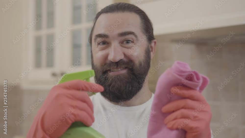 Portrait handsome man with perfect beard smiling and showing detergent ...