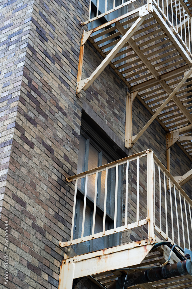 Old fire escape remains outside of brick building Stock Photo | Adobe Stock