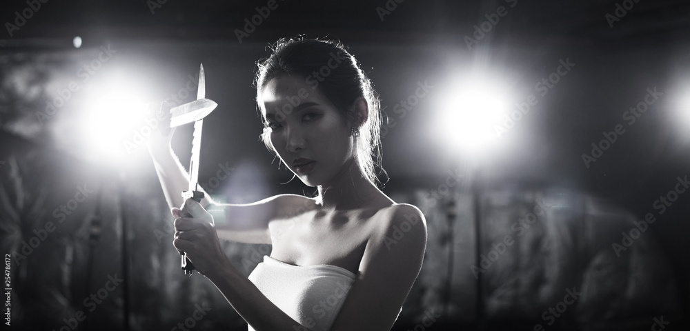 Beautiful Asian Woman demonstrates practice martial art knife technique ...
