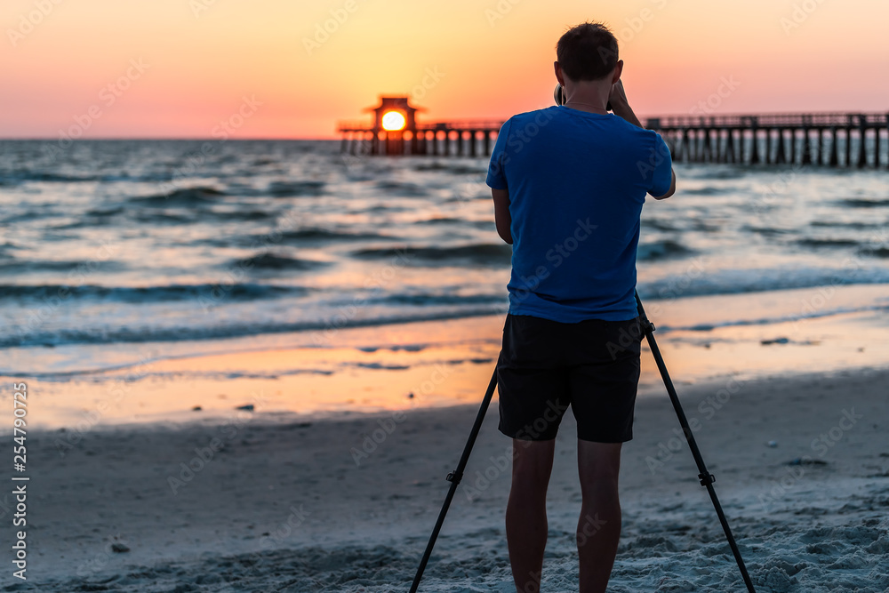 Naples, Florida sunset in gulf of Mexico with sun setting inside Pier ...