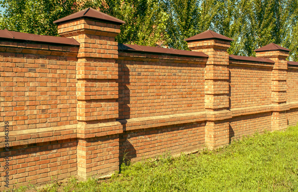 Red brick fence, beautiful summer day, green plants Stock Photo | Adobe ...