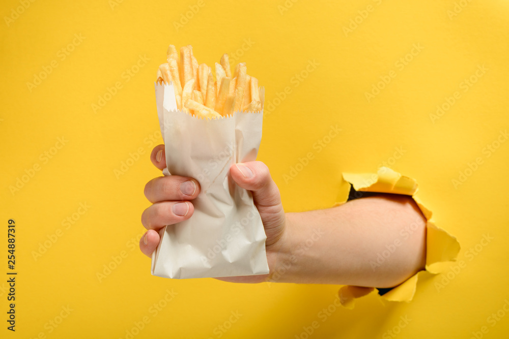 Hand taking French fries Stock Photo | Adobe Stock