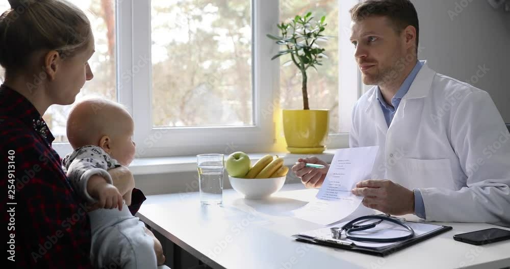 nutritionist and young mother with baby discussing healthy balanced ...