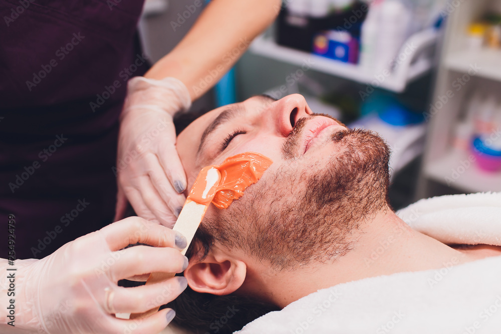 Hair removal. Man's face sugaring epilations beard trimming, yellow ...