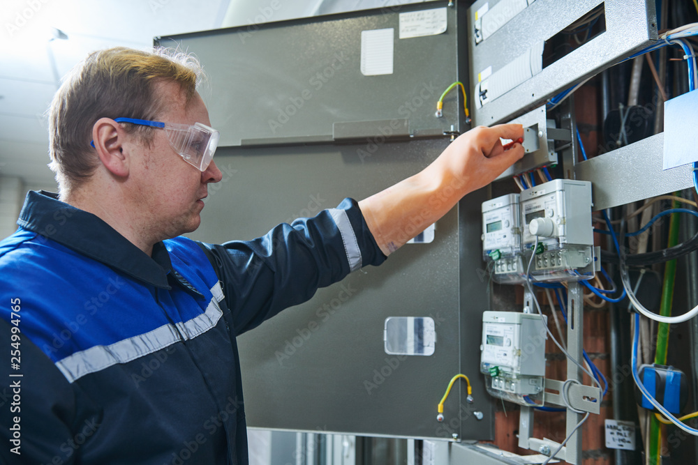 Electrician works in fuse box. Switching of circuit breaker Stock Photo ...