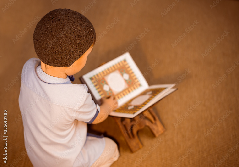 little boy reading the Quran Stock Photo | Adobe Stock