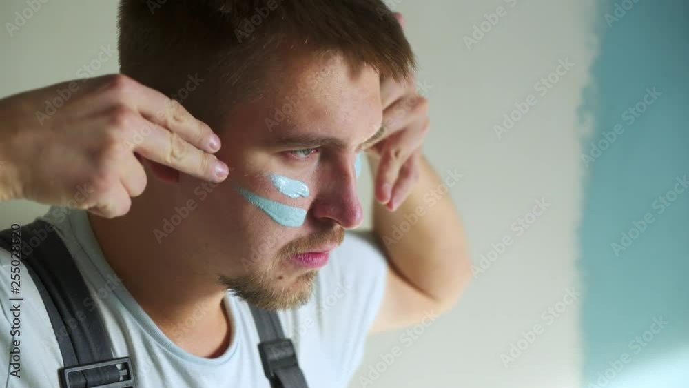 Builder man paint on his face battle color to paint the walls in the ...