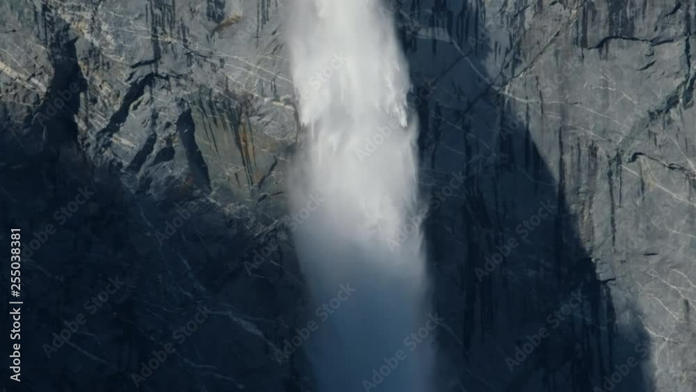 Water stream falling from a steep cliff from the melting glacier of the ...