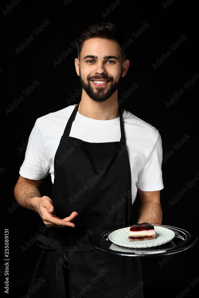 Handsome waiter with dessert on dark background Stock Photo | Adobe Stock