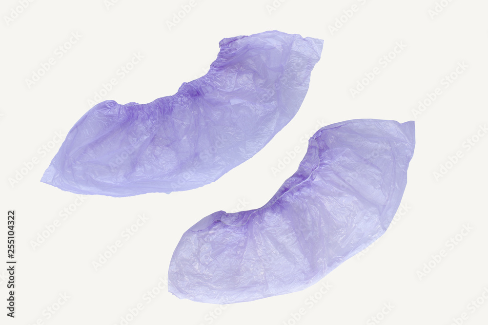 Two medical purple shoe covers overshoes isolated on white background ...