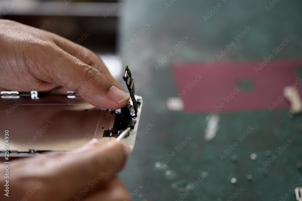 technician repairing broken mobile phone repair with a mobile phone ...